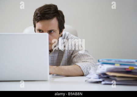 man sitting hunched over looking down drunk outside beach side bar in ...