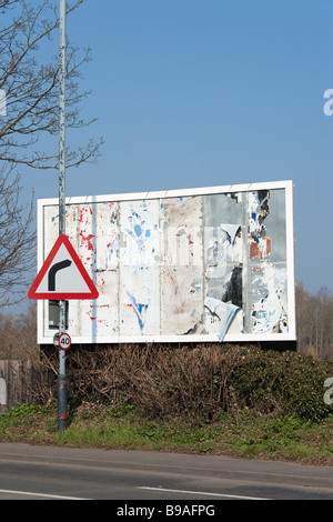 An unused, empty advertising billboard and roadsign in juxtaposition ...