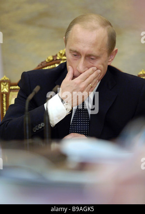 Russian President Vladimir Putin look through binoculars during the ...