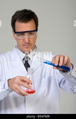 A scientist mixing liquids at the lab Stock Photo - Alamy
