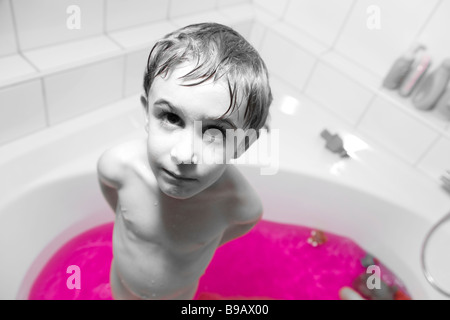 boy standing in bath tub with pink water Stock Photo, Royalty Free ...