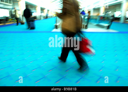 man and woman running through an airport in a rush to catch their Stock ...