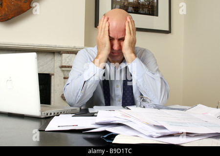 man working on his accounts and worrying about figures Stock Photo - Alamy