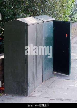 A roadside telecoms box with the door open, showing a tangle of wires ...