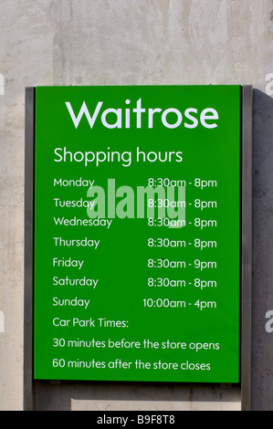Waitrose opening hours sign Stock Photo - Alamy