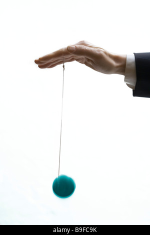 A vertical closeup shot of a person cutting tomatoes on a wooden board ...