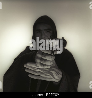 Man young "monk" face-tattoo seriously cowl pistol barefoot crime ...