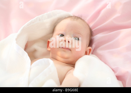 Baby lying supine position blankets portrait enveloped mother detail ...