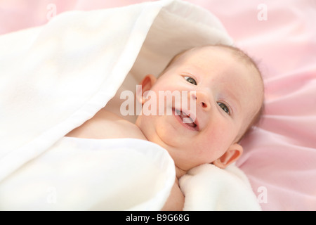 Baby lying supine position blankets portrait enveloped mother detail ...
