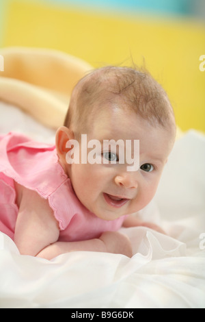 Baby lying prone position head lifts smiling portrait 4 months wakened ...