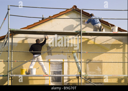 House-facade scaffolding plasterers work Stock Photo - Alamy