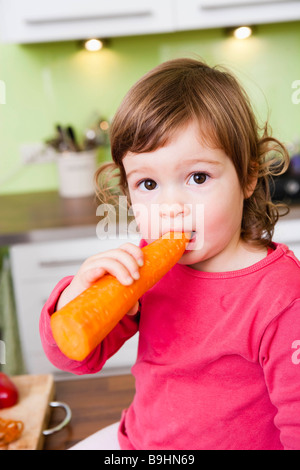 Happy baby eating carrot. Healthy nutrition for kids. Bio carrot as ...