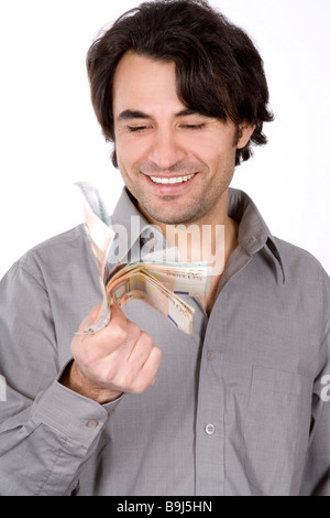 Young man fanning banknotes Stock Photo - Alamy