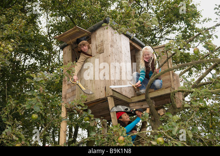 Girl climbing in treehouse outdoors Stock Photo - Alamy