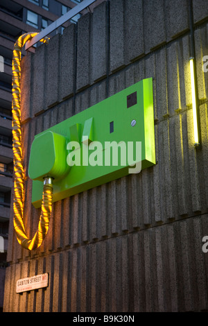 Giant huge green plug and light power energy switch socket on the wall ...
