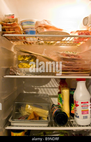 Domestic refrigerator full of a variety of foods, vegetables and fruits ...