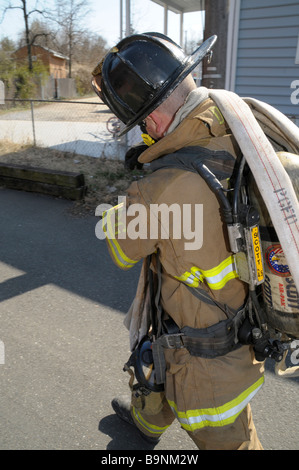 firefighter carrying hose on his shoulder in Bladensburg, Maryland ...