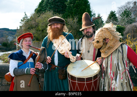 Woman musician wearing Medieval costume with white headband performing ...