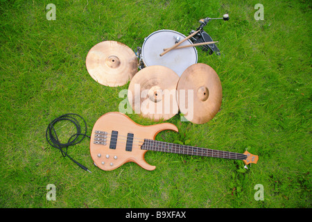 musical instruments, guitar, drum, plates on grass Stock Photo - Alamy