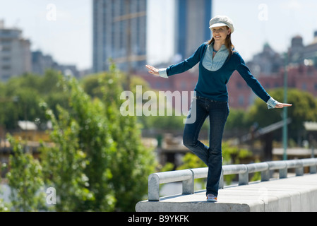Young hipster woman standing on grassland holding hot coffee and enjoy ...