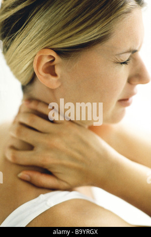 Woman touching the nape of her neck, side view, cropped Stock Photo - Alamy