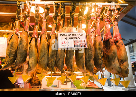 Hams hang in butcher shop in Madrid Spain Stock Photo - Alamy