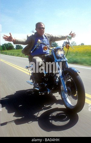 Caucasian man riding motorcycle with no hands Stock Photo - Alamy