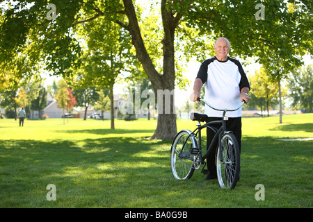 Smiling senior adult man standing outside in the garden Stock Photo - Alamy