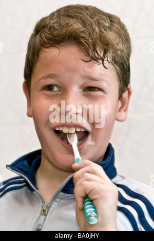 Boy washing teeth with toothbrush Stock Photo - Alamy