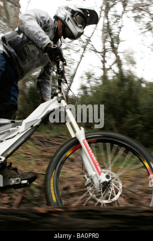 A downhill bike rider rides around a berm Stock Photo - Alamy