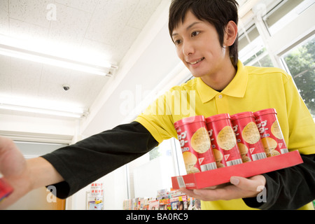 Convenience store clerk displaying Stock Photo - Alamy