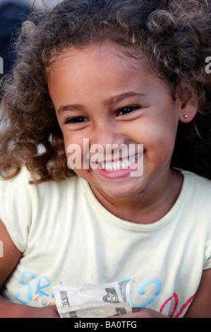 Pretty young smiling Cuban girl with sombrero and colorful dress ...