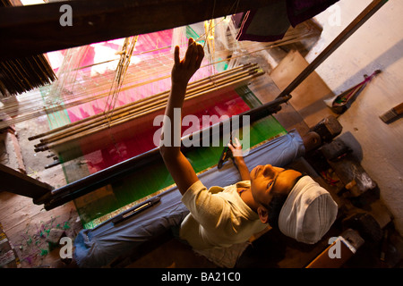 Weaver weaving Varanasi sari silk thread with handloom in Varanasi ...