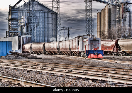 This is an HDR image of a train locomotive engine on railroad tracks ...