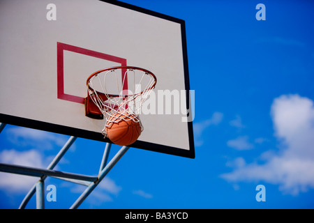 Basketball going through the hoop at a sports arena (intentional ...