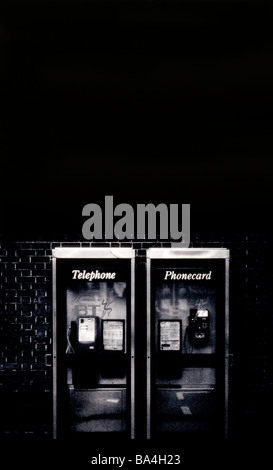 Black public telephone box kiosk and information point in the centre of ...