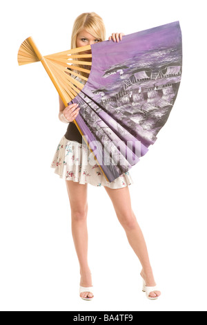 blond woman with large fan on a white background Stock Photo - Alamy