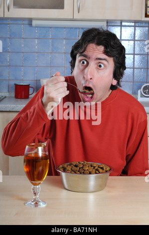 Man eating dog food Stock Photo - Alamy