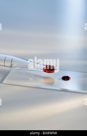 High angle shot of a blood test sample with positive result in a doctor ...