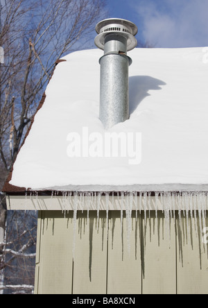 Icicles hang from the roof with snow Stock Photo - Alamy