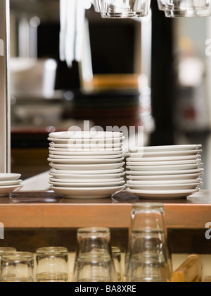 Clean dishes in the restaurant on the shelves. Multicolored plates in ...