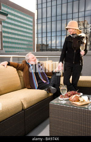 Middle-aged couple on rooftop of modern downtown loft Stock Photo - Alamy