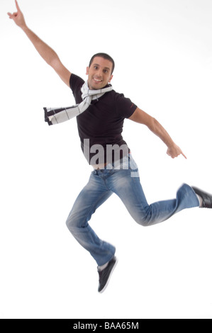 A handsome young man leaps in the air with excitement, embracing a ...