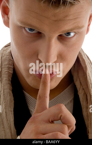 handsome young guy shushing Stock Photo - Alamy