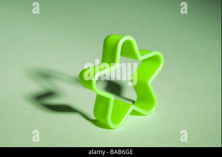 Horizontal close-up of a green star-shaped peony seed capsule ...