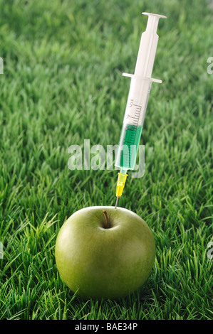 Injecting green apple medical syringe genetically modified foods Stock ...