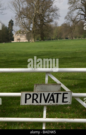 A gate marked private with a country house in the distance. The private ...