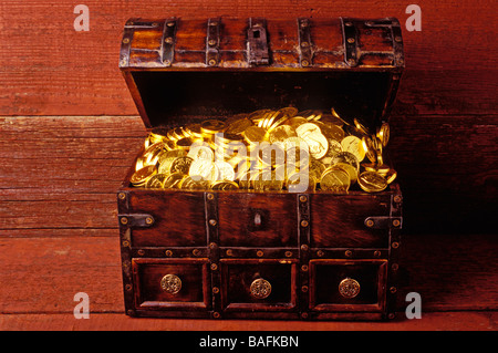 Treasure chest full of gold bars on black background Stock Photo ...