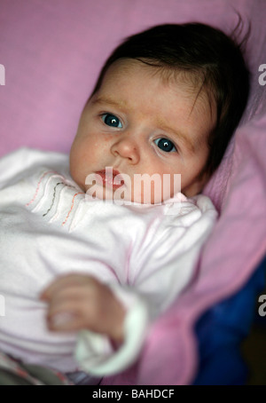Close-up portrait of happy baby boy wearing cap while sitting on chair ...