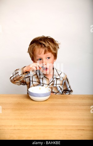 Wooden Spoon with White Bowl with Five Tomatoes Placed on Yellow Cloth ...